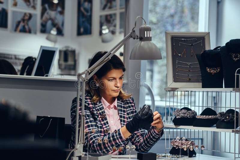 Female Jewelry Worker Elegantly Dressed Sitting at Work Table and Make ...