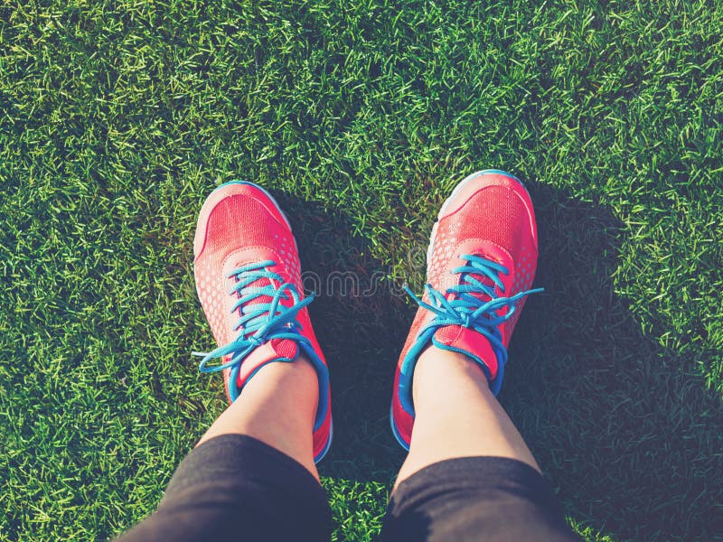 Female Jogger Looking Down at Her Feet Stock Image - Image of field ...