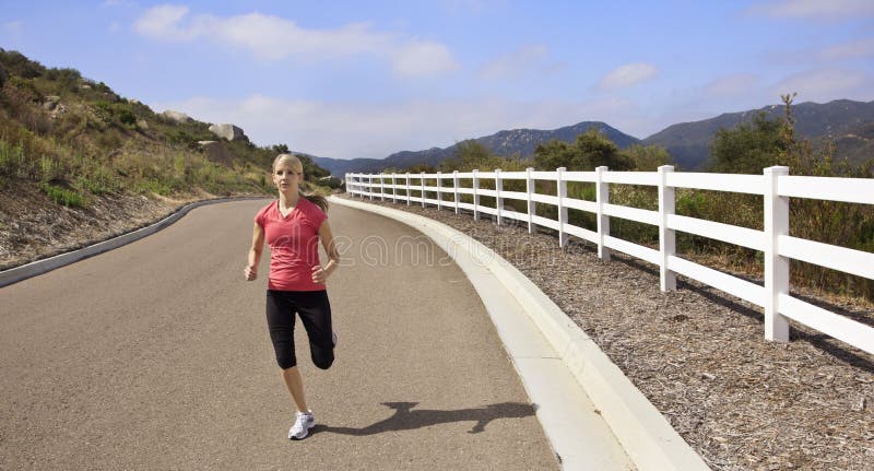Female Jogger Running on the Road Stock Image - Image of angle ...