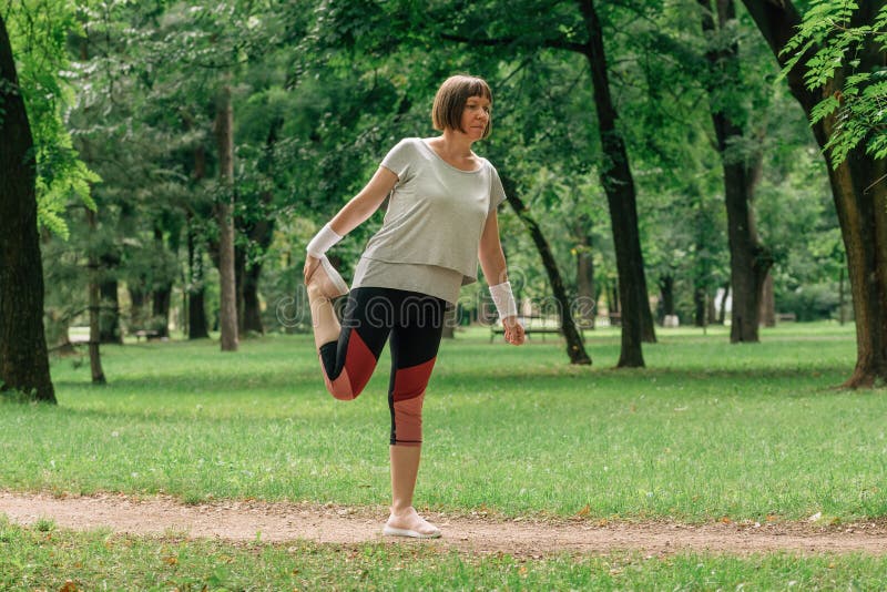 Female Jogger Stretching Muscles and Warming Up for Running Exercise in ...