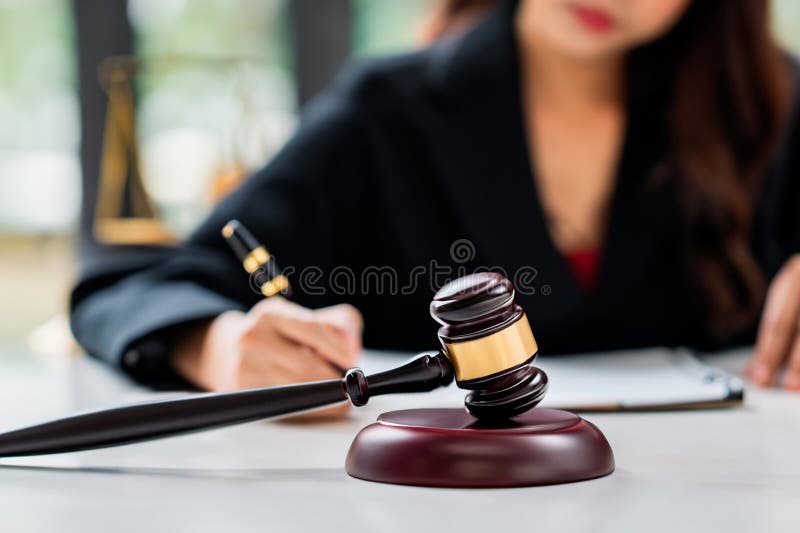 Female Judge Taking Notes during the Court Session. There is a Judge ...