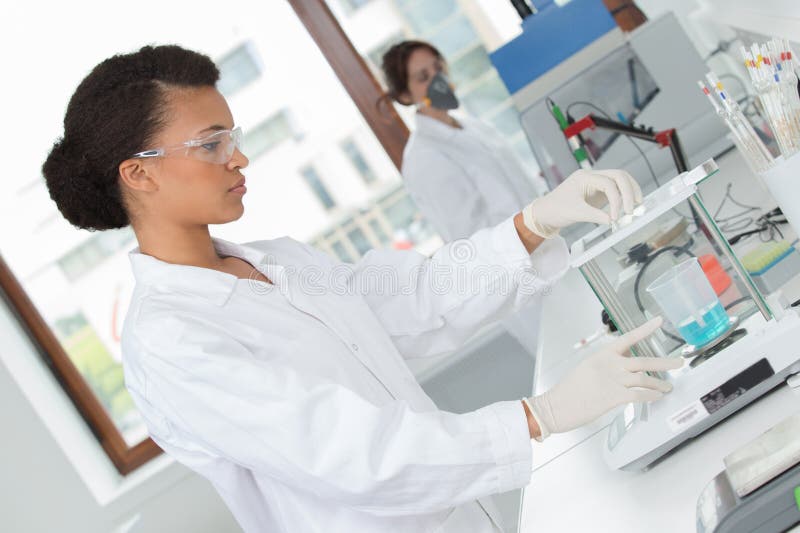 Female Lab Assistant Studying Blood Sample for Analysis Stock Photo ...