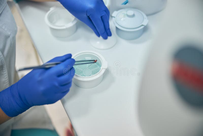 Female Lab Assistant Using Blue Liquid in Work Stock Image - Image of ...