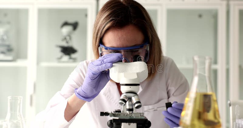 Female Lab Worker Pours Sample of Reagent on Microscope Stage Stock ...