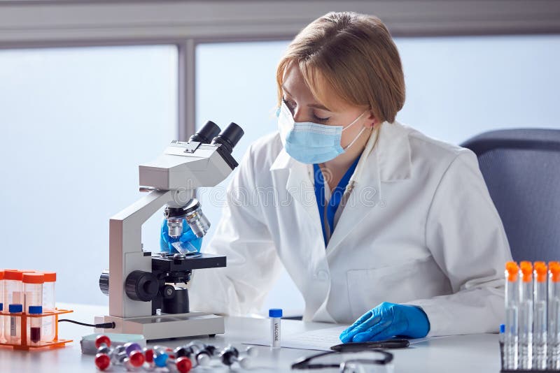 Female Lab Worker Wearing PPE Analysing Blood Samples in Laboratory ...