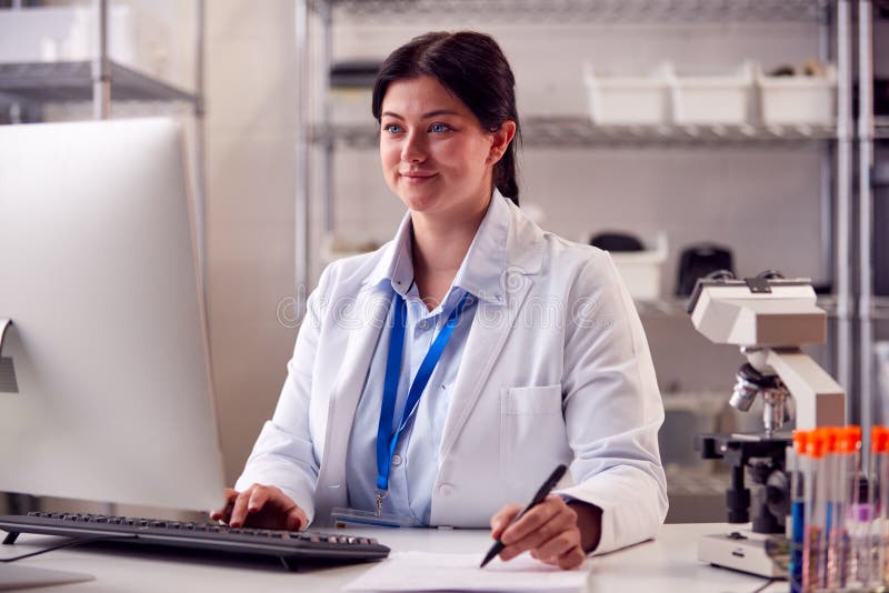 Female Lab Worker Wearing PPE Face Shield Recording Blood Test Results ...