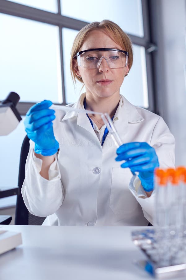 Female Lab Worker Wearing White Coat Using Pipette and Test Tube in ...