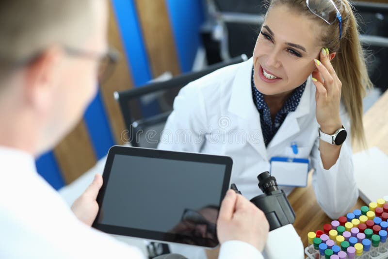Female Laborant Sit on Chait, Examines Biomaterial with Microscope and ...