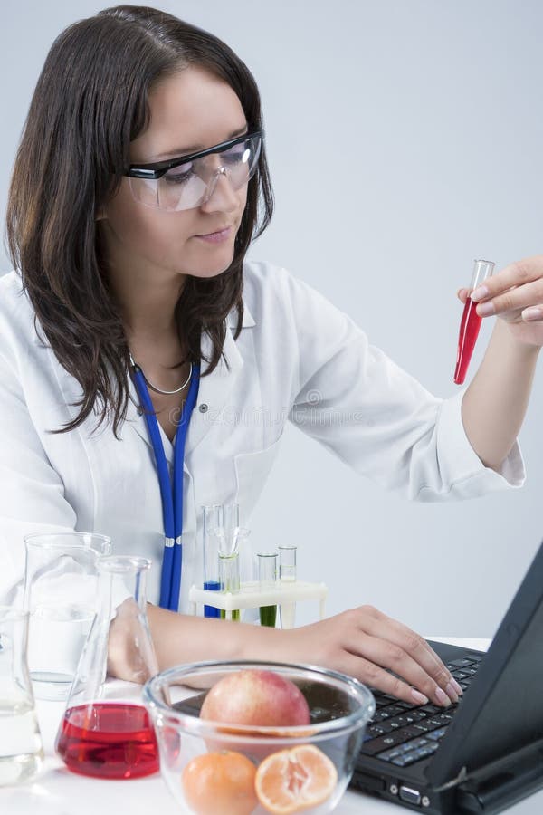 Female Laboratory Assistant with Different Test Flasks Conducting ...