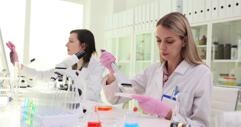 Female Laboratory Worker Pours Specimen Using Test Pipette Stock ...