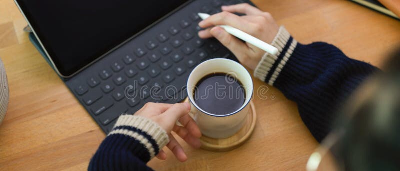 Female Left Hand Holding Coffee Cup and Right Hand Using Digital Tablet ...