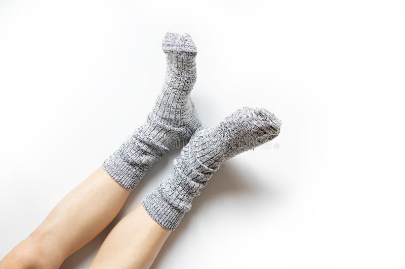 Female Legs and Light Knitted Thick Warm Socks on Bare Female Legs on a ...