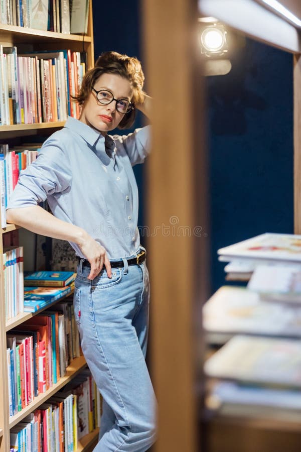 Female Librarian in Glasses Reading a Book Stock Photo - Image of ...