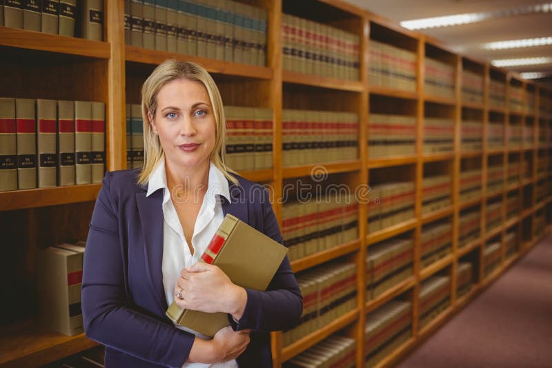 Female Librarian Posing and Holding a Book Stock Photo - Image of ...