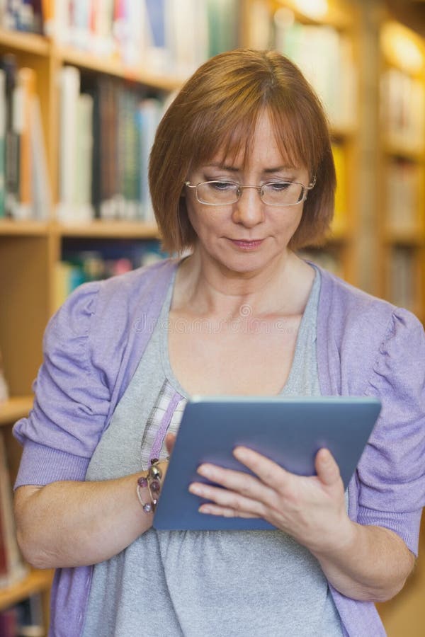 Female Librarian Using Concentrated Her Tablet Stock Image - Image of ...