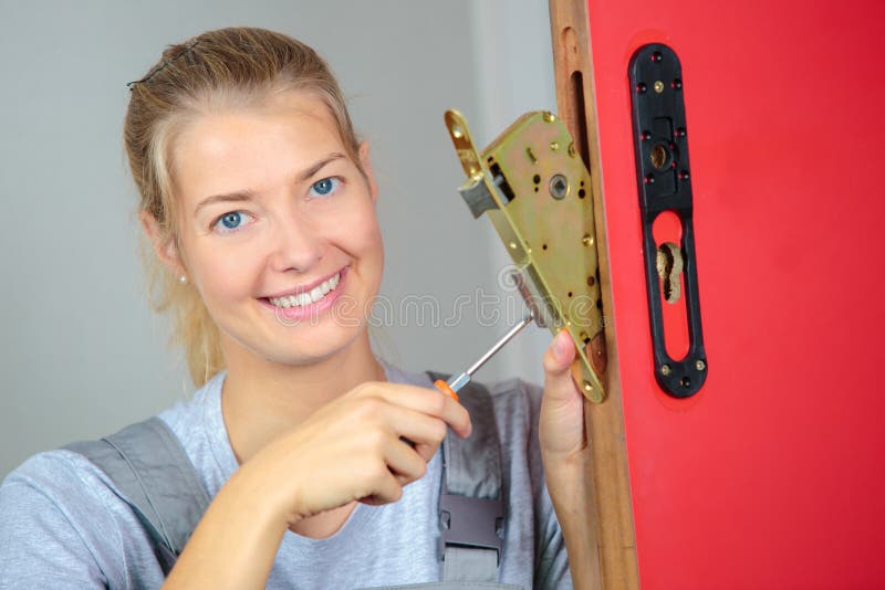 Female Lock Smith Posing and Smiling Stock Photo - Image of lock, house ...