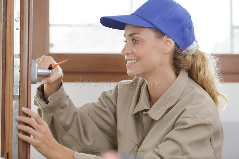 Female Lock Smith Posing and Smiling Stock Image - Image of door, build ...