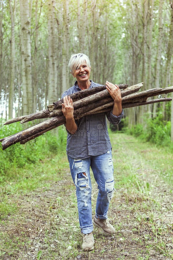 Female Lumberjack Carrying a Stack of Trunks Stock Image - Image of ...