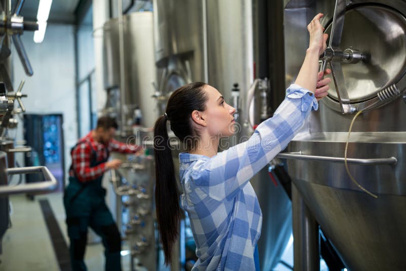 A Female Maintenance Worker Holds a Wrench beside a Tanker Train Stock ...