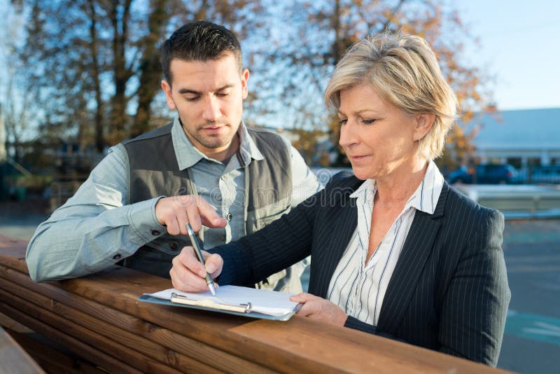 Female and Male Employee Writing Notes Outdoors Stock Photo - Image of ...