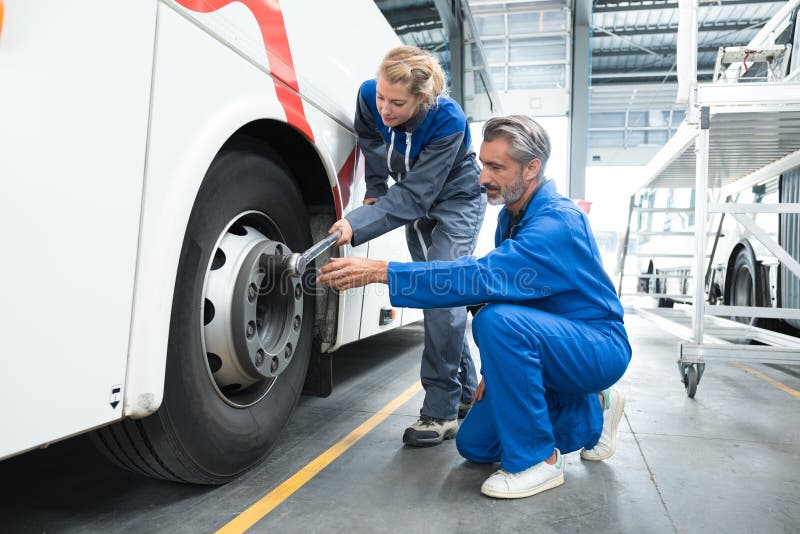 Female and Male Mechanic Working on Bus Stock Photo - Image of champion ...