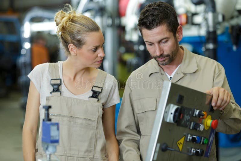 Female and Male Operating Machine in Factory Stock Image - Image of ...