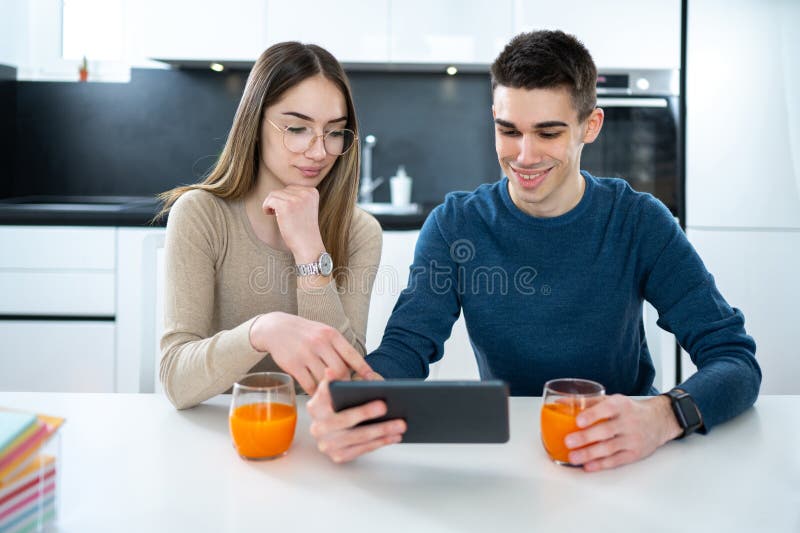Female and Male Students Using Tablet Together and Drinking Juice at ...