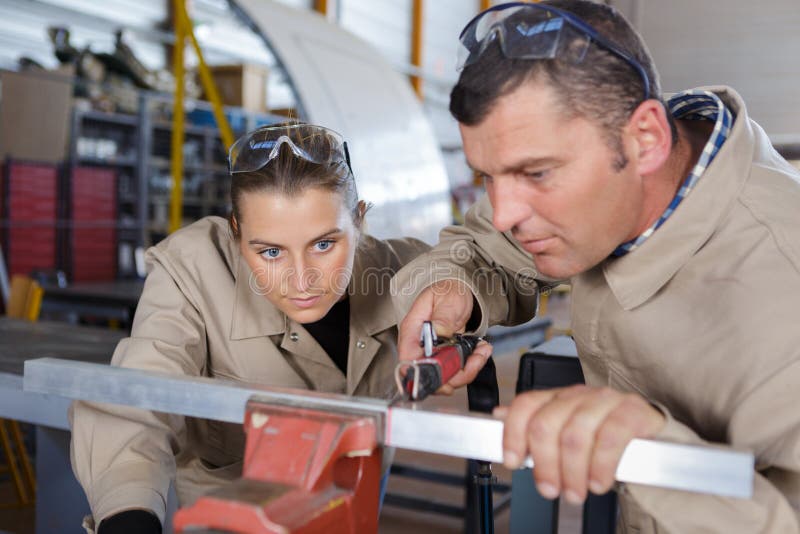 Female and Male Worker Cutting Metal Profiles in Workshop Stock Image ...