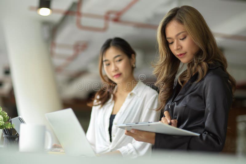Female Manager Focused on Checking the Work Process on Paperwork Stock ...