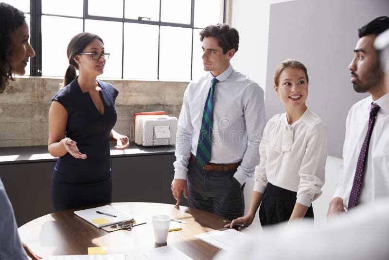 Female Manager in Glasses Addressing Team in Meeting Stock Photo ...