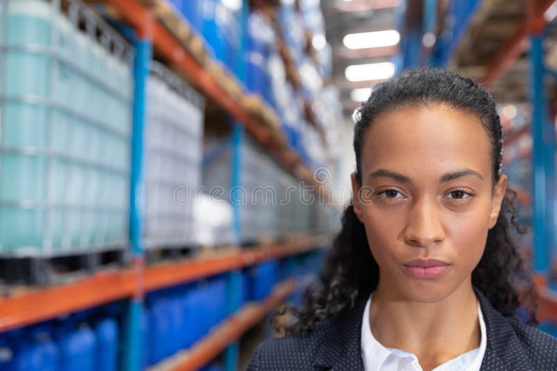 Manager Looking at Camera while Using Digital Tablet in Warehouse Stock ...