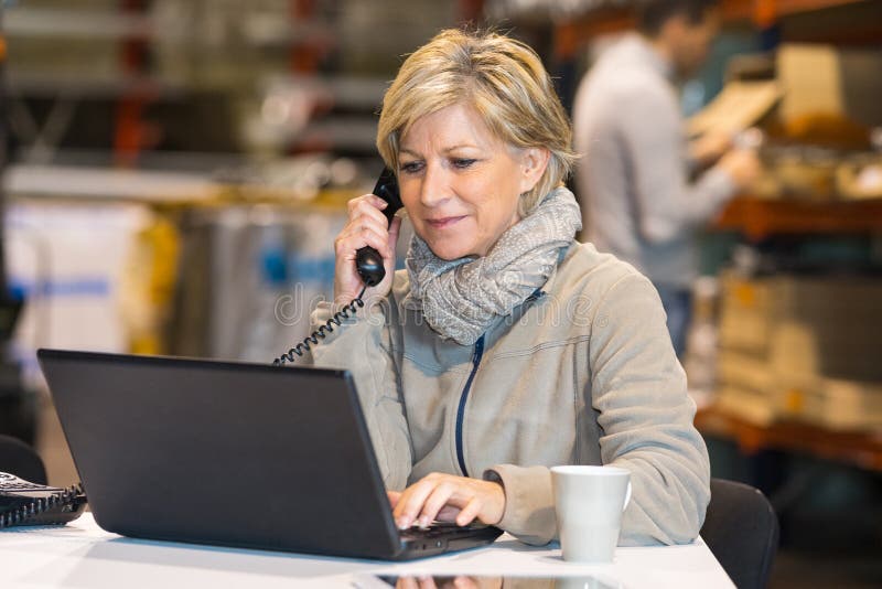 Female manager on phone stock image. Image of shelves - 212233227