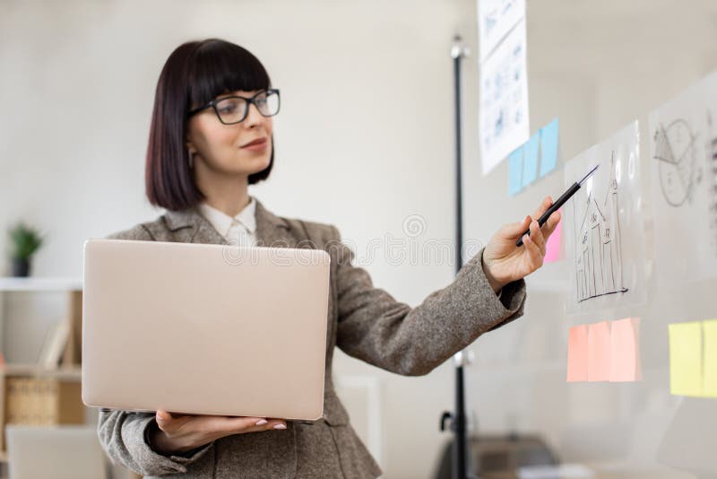 Female Manager Preparing for Presentation, Writing Notes on Stickers ...