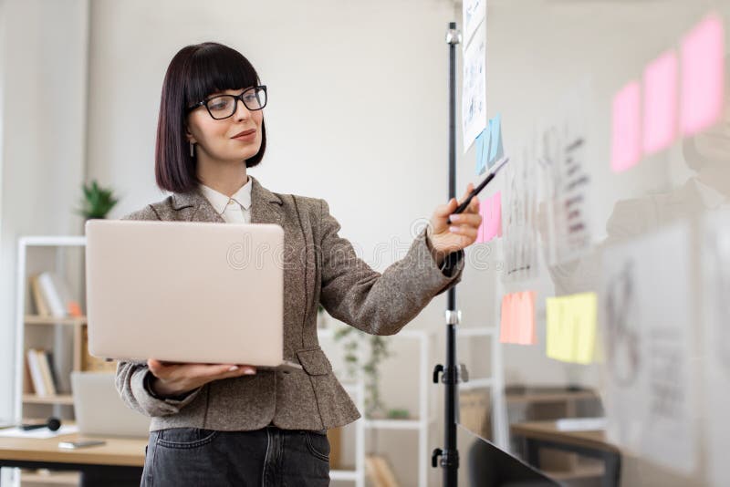 Female Manager Preparing for Presentation, Writing Notes on Stickers ...