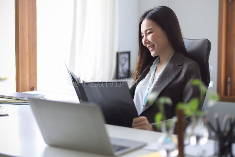 Female Manager Reading the Informations on a Document Stock Photo ...