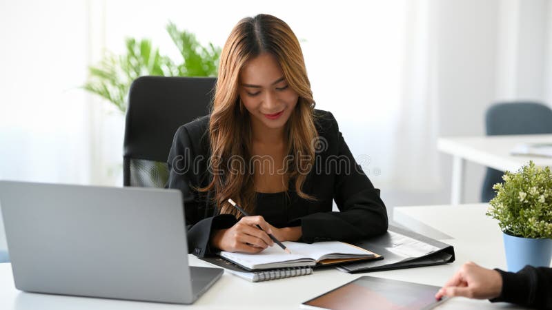 Female Manager Sitting and Taking a Notes on Her Diary Stock Image ...