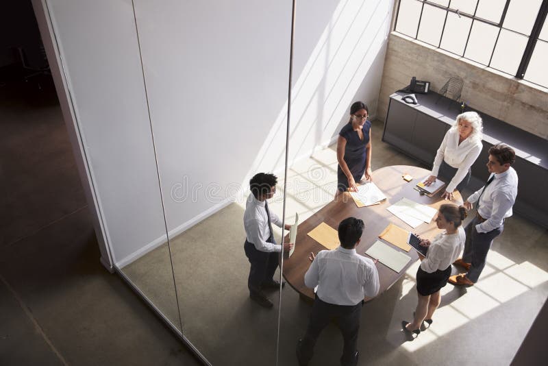 Female Manager in Team Meeting, Elevated View through Window Stock ...