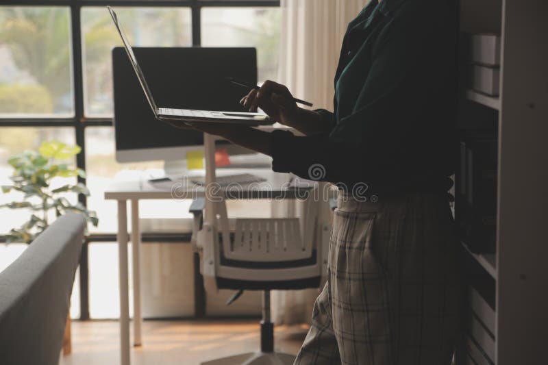 Female Manager Using Laptop Computer To Check Inventory. in the ...