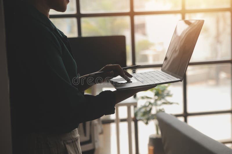 Female Manager Using Laptop Computer To Check Inventory. in the ...