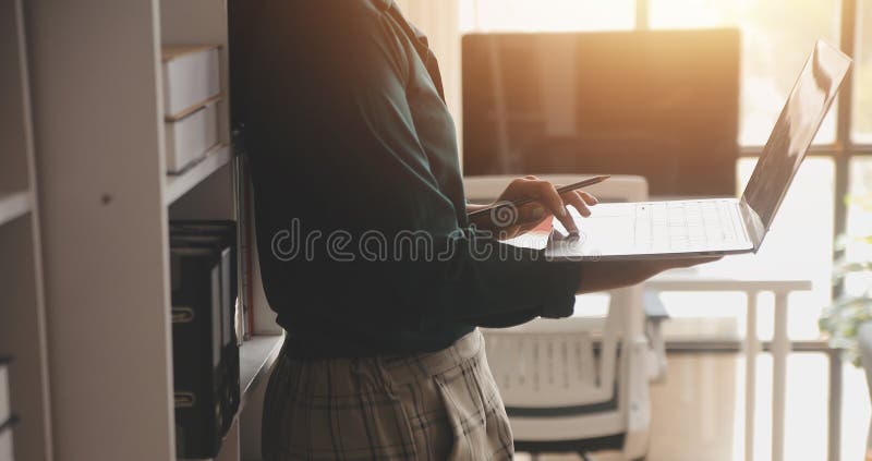 Female Manager Using Laptop Computer To Check Inventory. in the ...