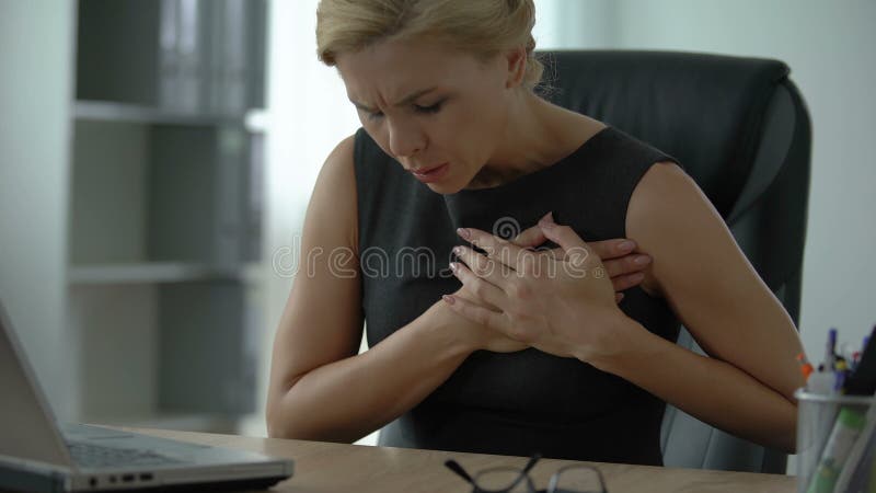 Female Manager Working on Computer, Suffering from Sharp Chest Pain ...