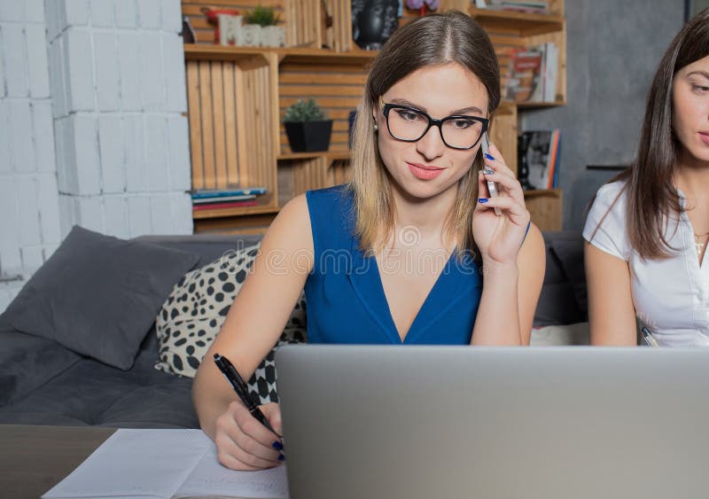Female Marketing Writer Having Cellphone Conversation Using Net-book ...