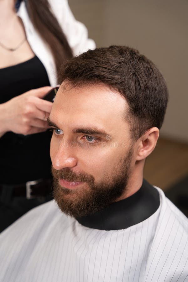 Female Master Cuts a Bearded Client with a Clipper Stock Image - Image ...