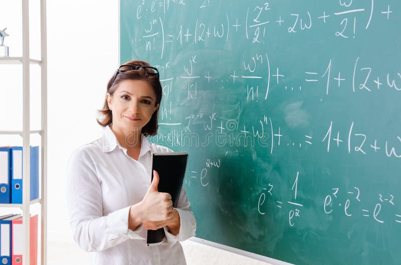 The Female Math Teacher in Front of the Chalkboard Stock Photo - Image ...