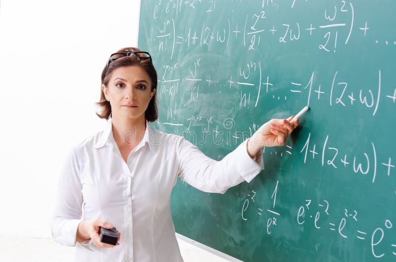 The Female Math Teacher in Front of the Chalkboard Stock Photo - Image ...