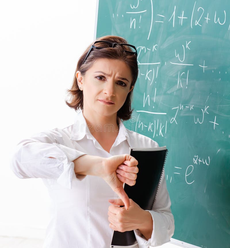 Female Math Teacher in Front of the Chalkboard Stock Photo - Image of ...