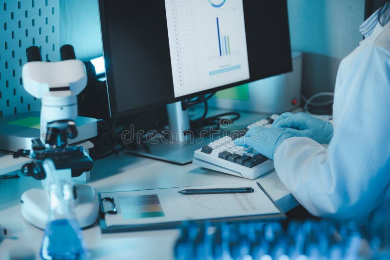 Female Medic in Uniform Working with Microscope Making Analysis at the ...