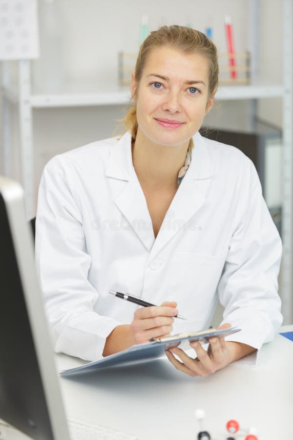Female Medic in White Coat Sitting at Desk in Office Stock Image ...