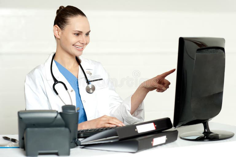 Female Medical Expert Pointing at Computer Screen Stock Image - Image ...