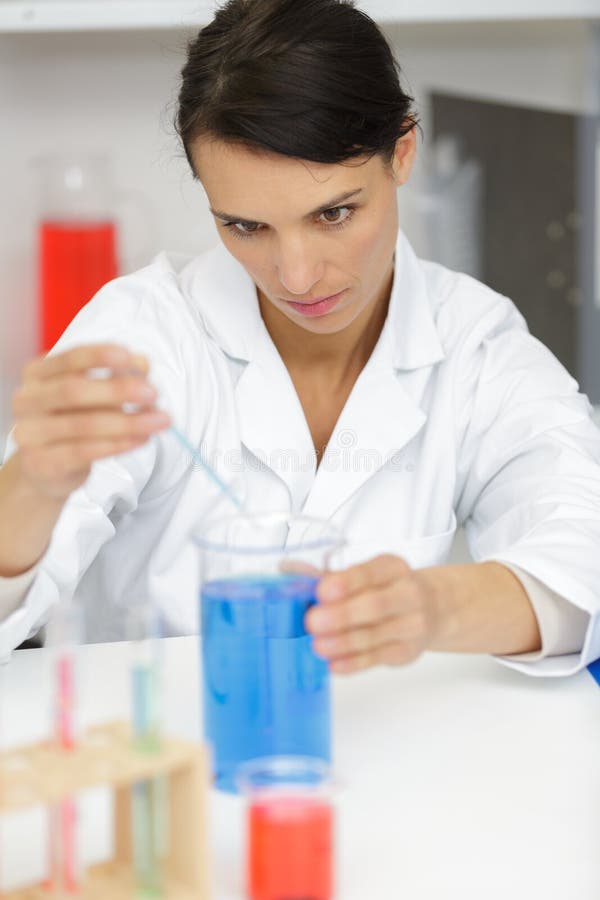 Female Mixing Blue Liquid in Beaker Stock Photo - Image of anasis ...